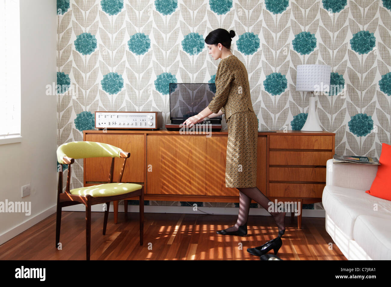 Woman in vintage dress playing records Stock Photo - Alamy