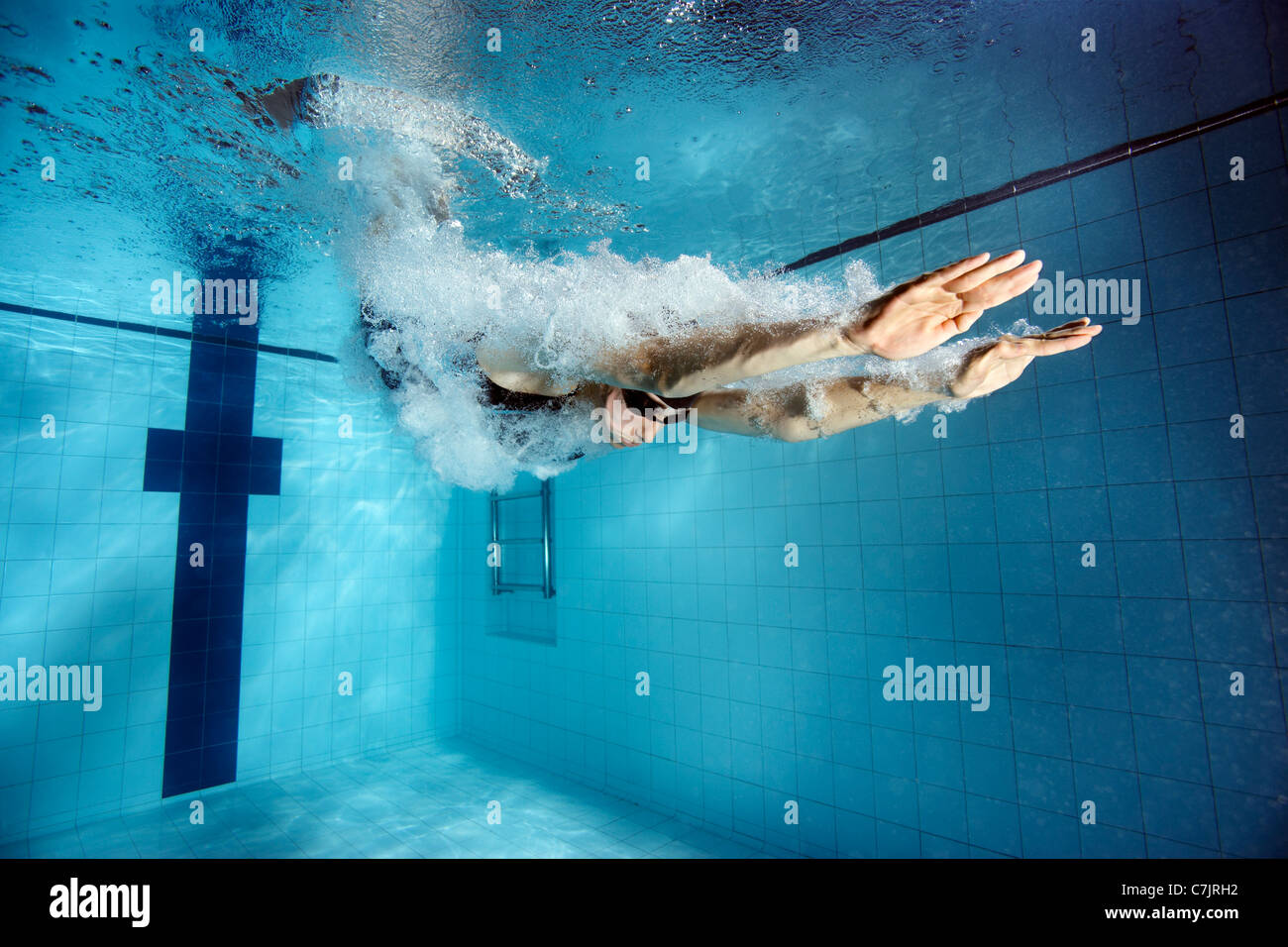 Swimmer diving into pool Stock Photo - Alamy