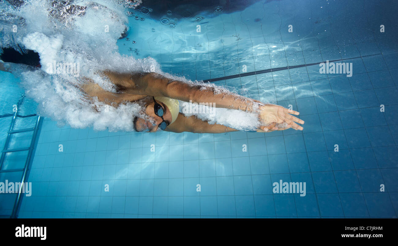 Swimmer diving into pool Stock Photo - Alamy