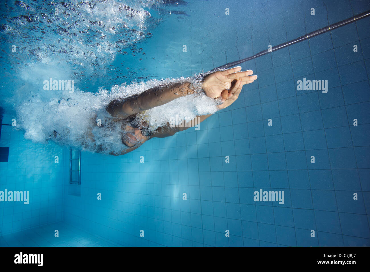 Swimmer diving into pool Stock Photo - Alamy