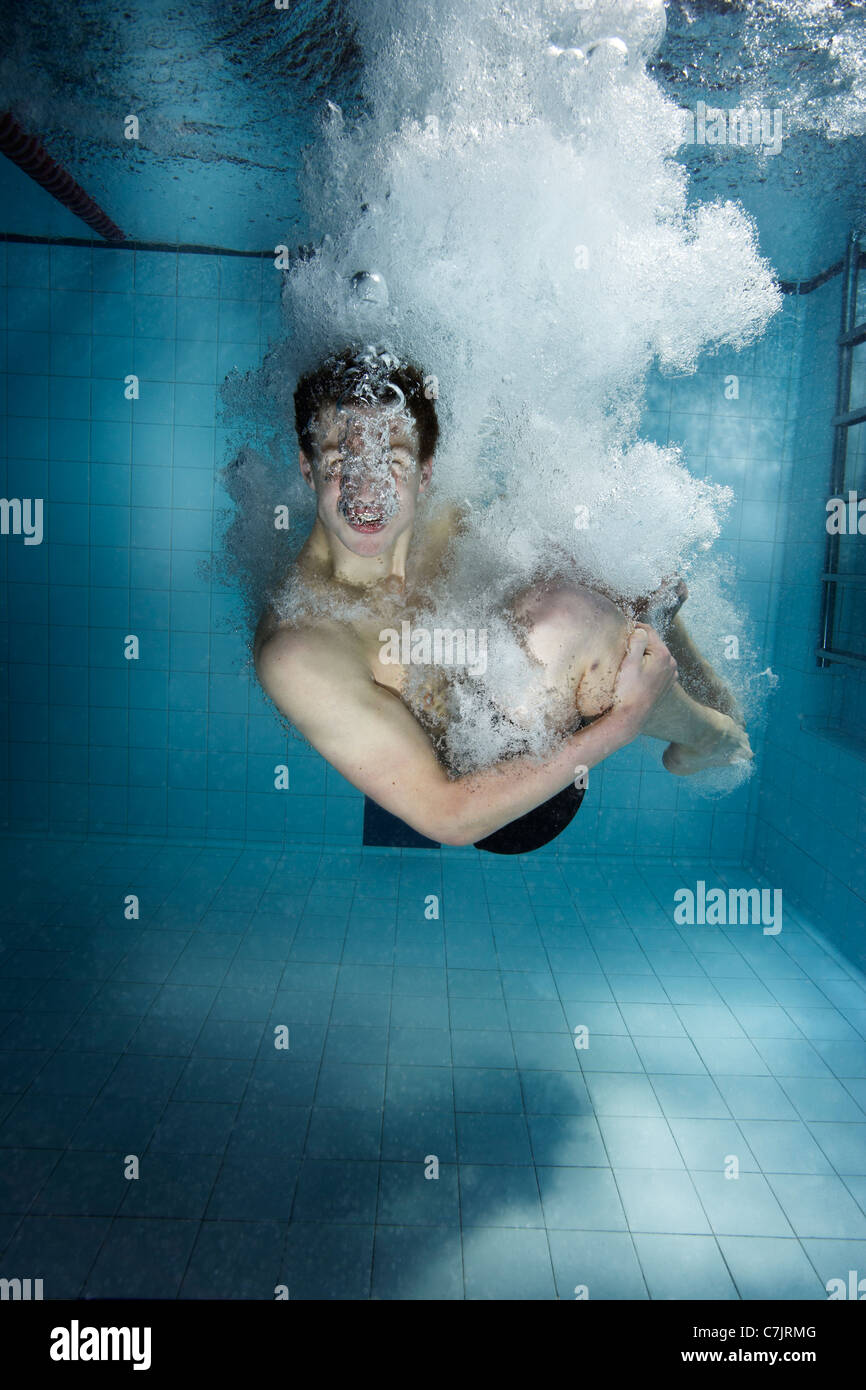 Swimmer jumping into pool Stock Photo - Alamy