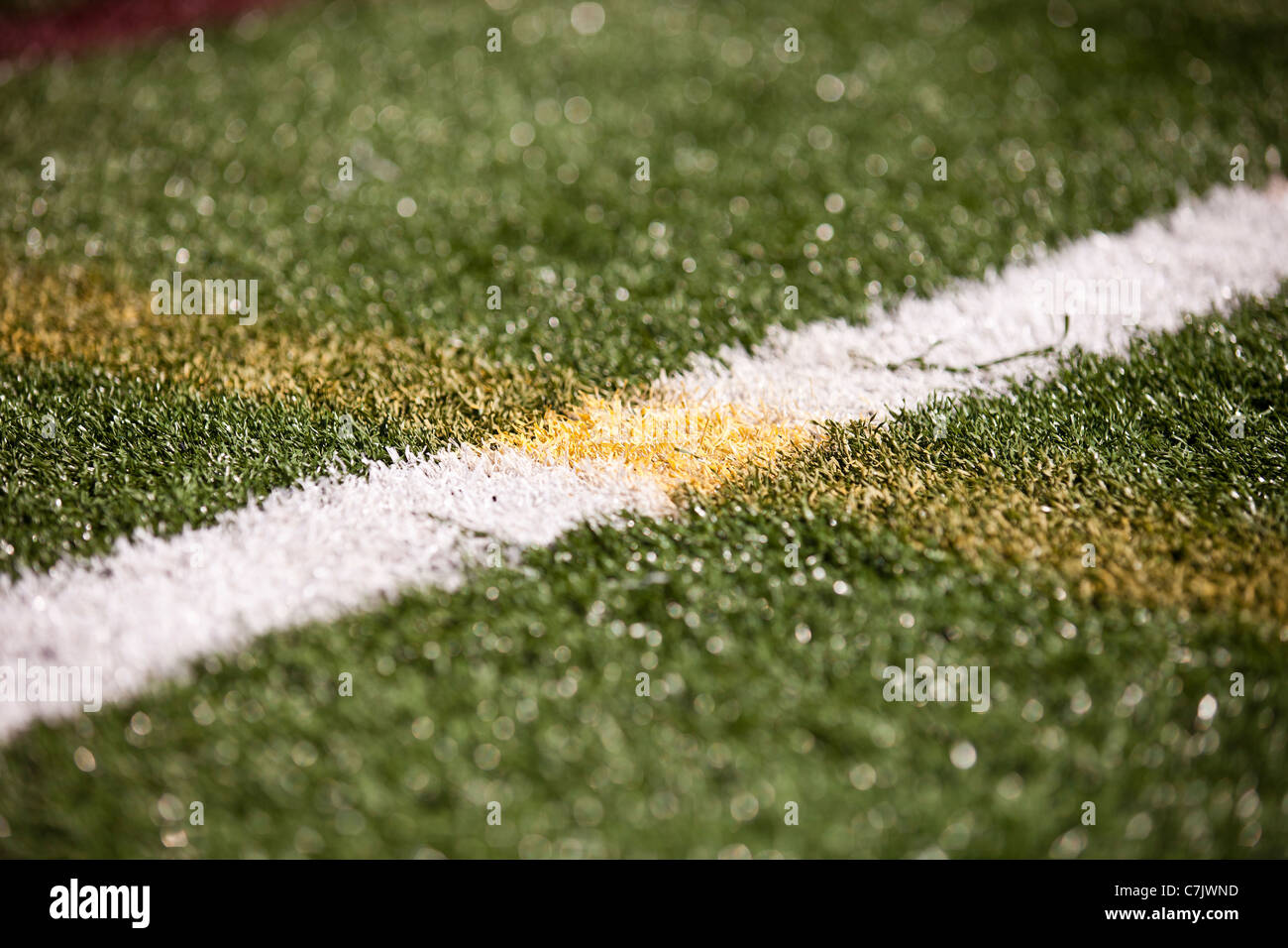 Astro Turf with white and yellow soccer lines Stock Photo - Alamy