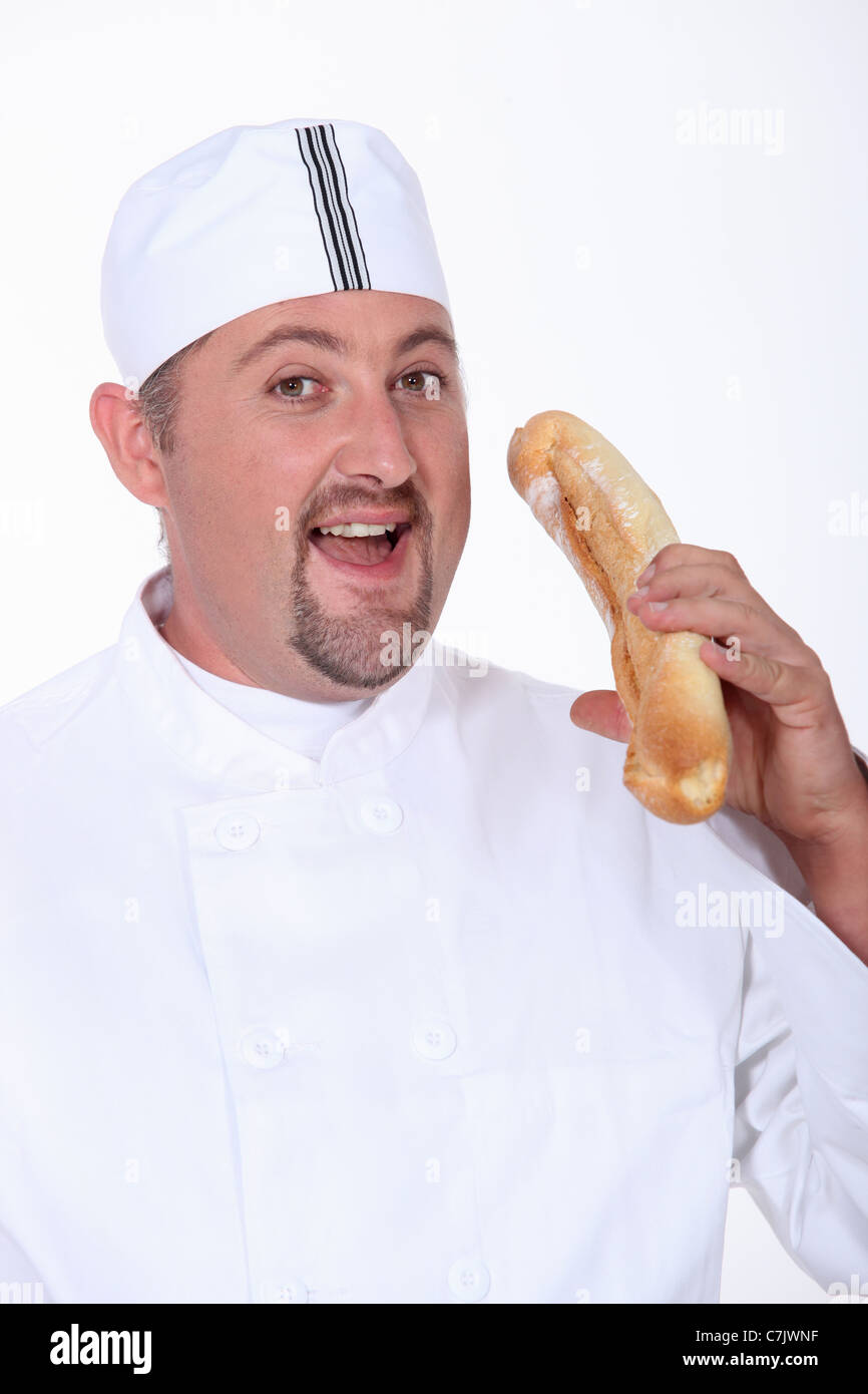 puffy man dressed in baker is eating bread Stock Photo - Alamy