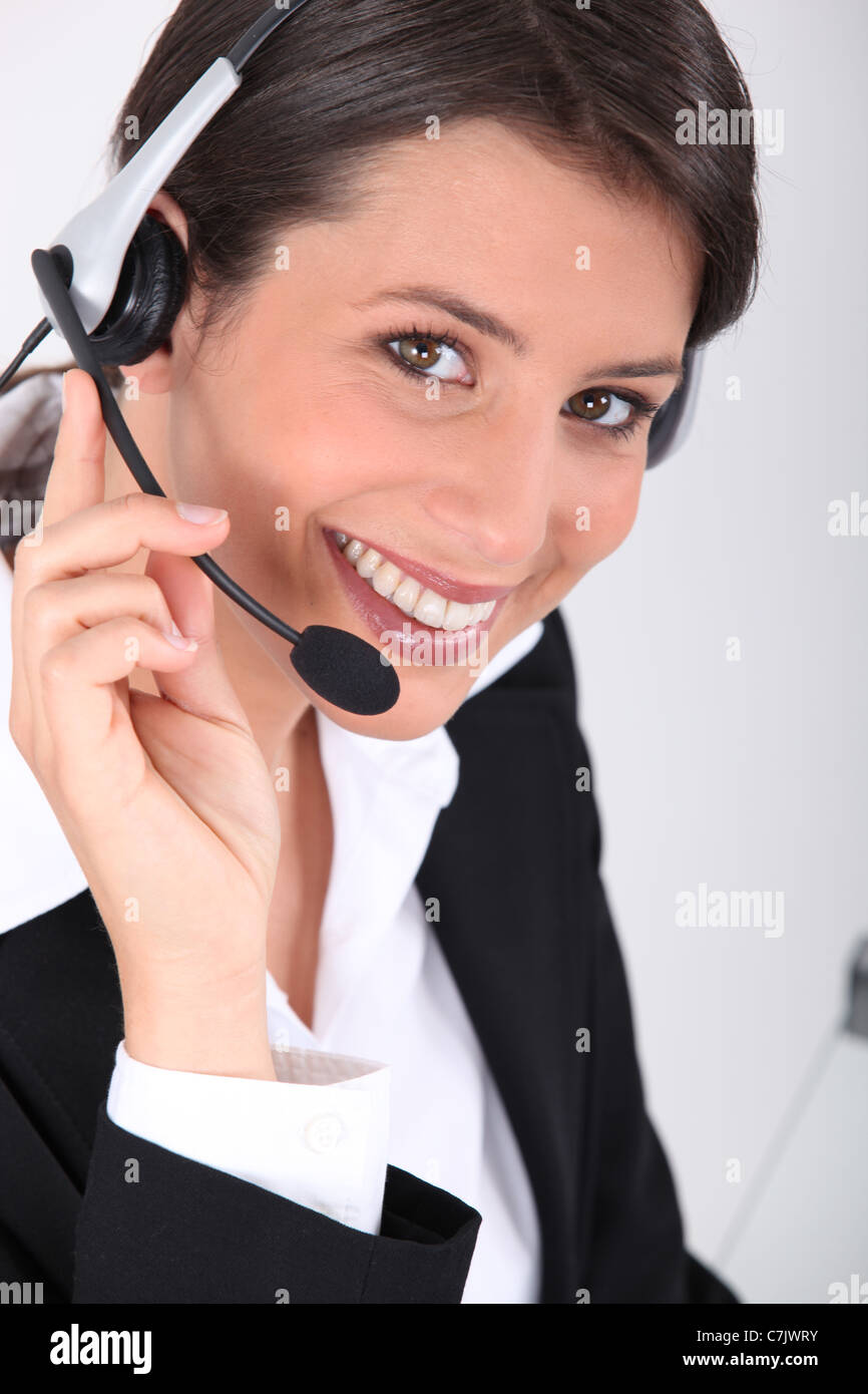 Smiling woman with headset Stock Photo - Alamy