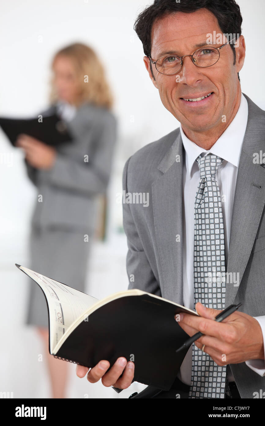 Businessman checking diary Stock Photo - Alamy