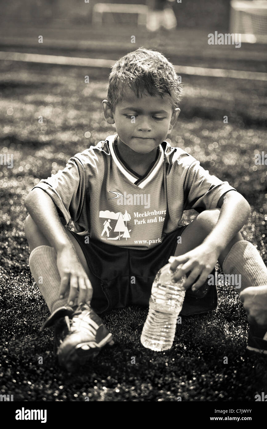 Young soccer player sitting Stock Photo - Alamy