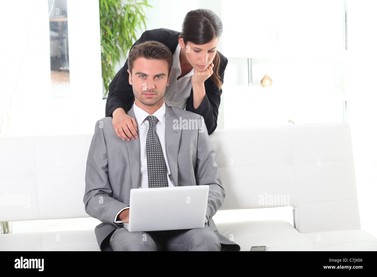 Couple using a laptop computer Stock Photo - Alamy