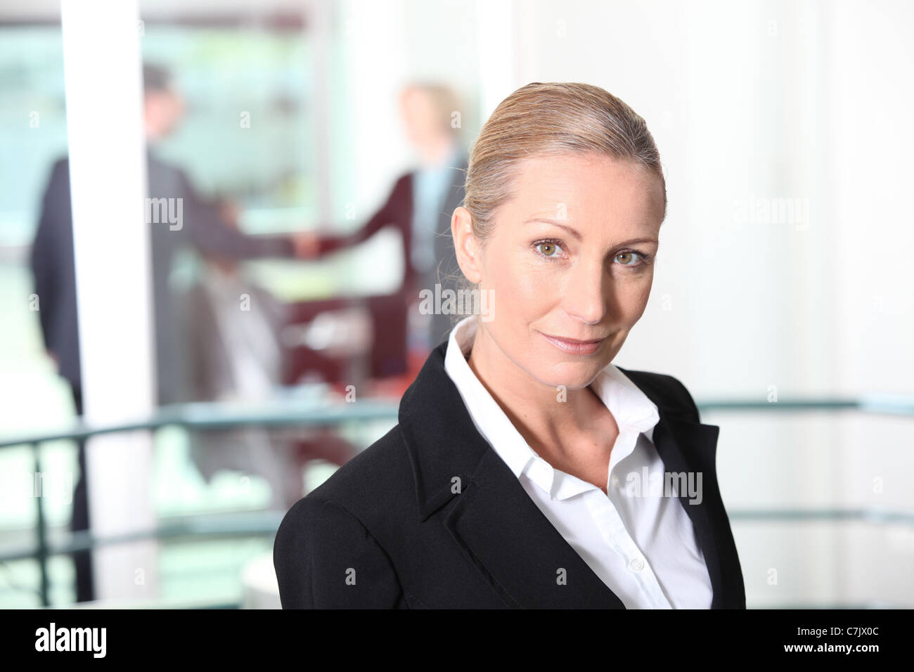 No-nonsense businesswoman in an office environment Stock Photo - Alamy
