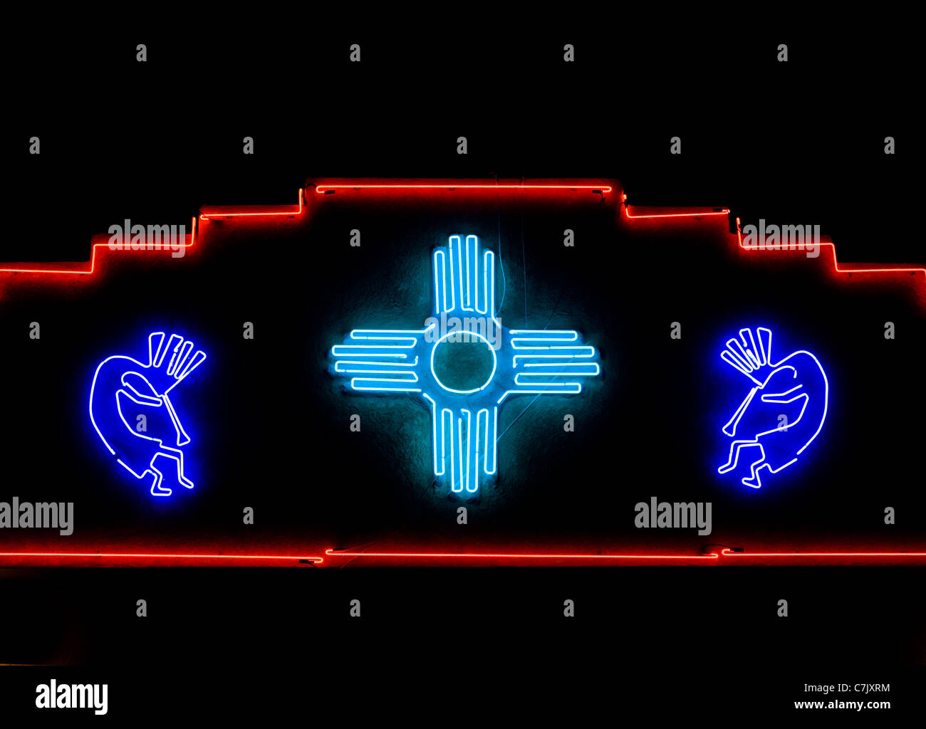 The Zia sun symbol and fertility deity Kokopelli glow in neon against ...