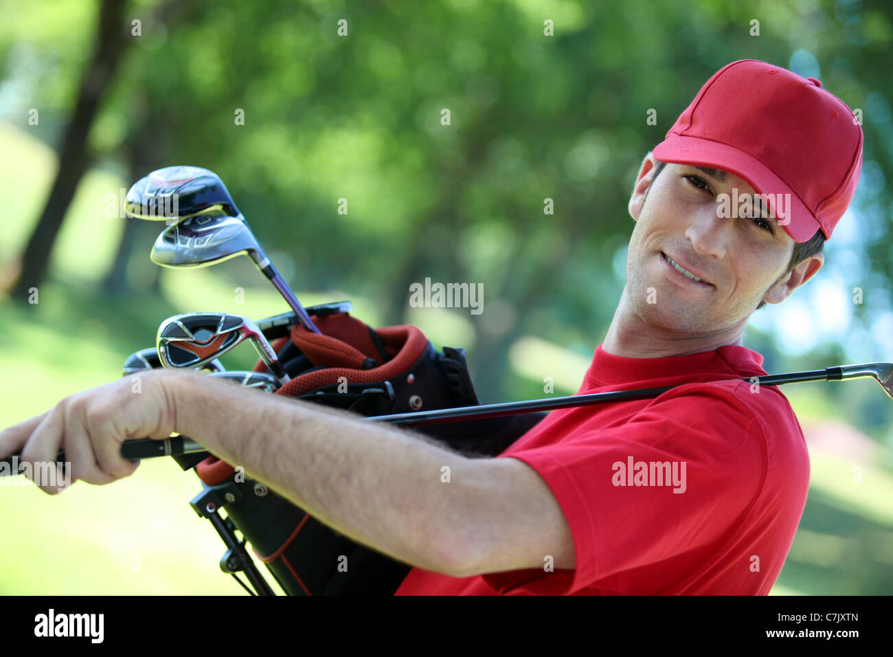 Golfer holding club over his shoulder Stock Photo - Alamy