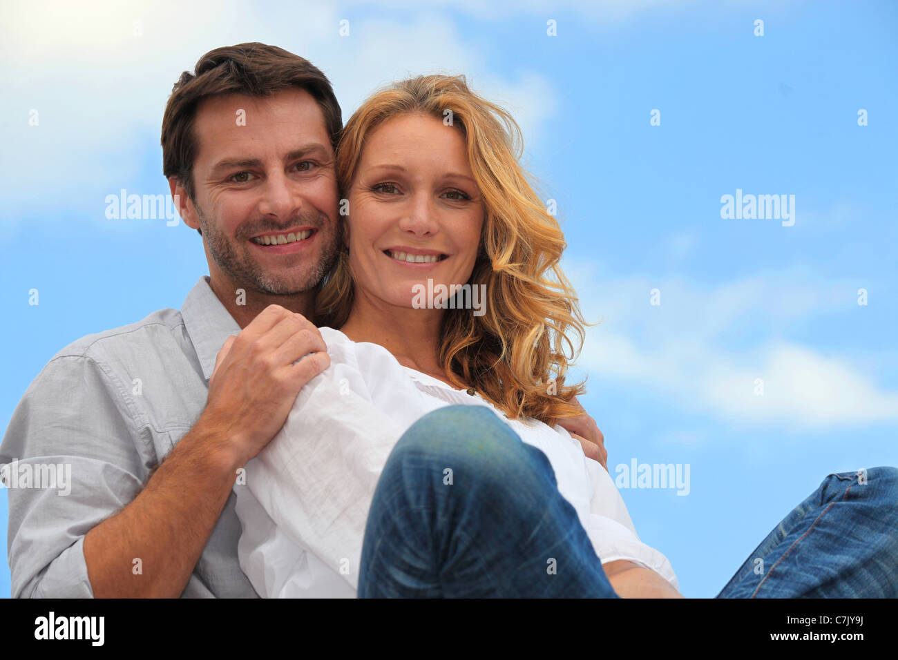 couple in blue sky Stock Photo - Alamy