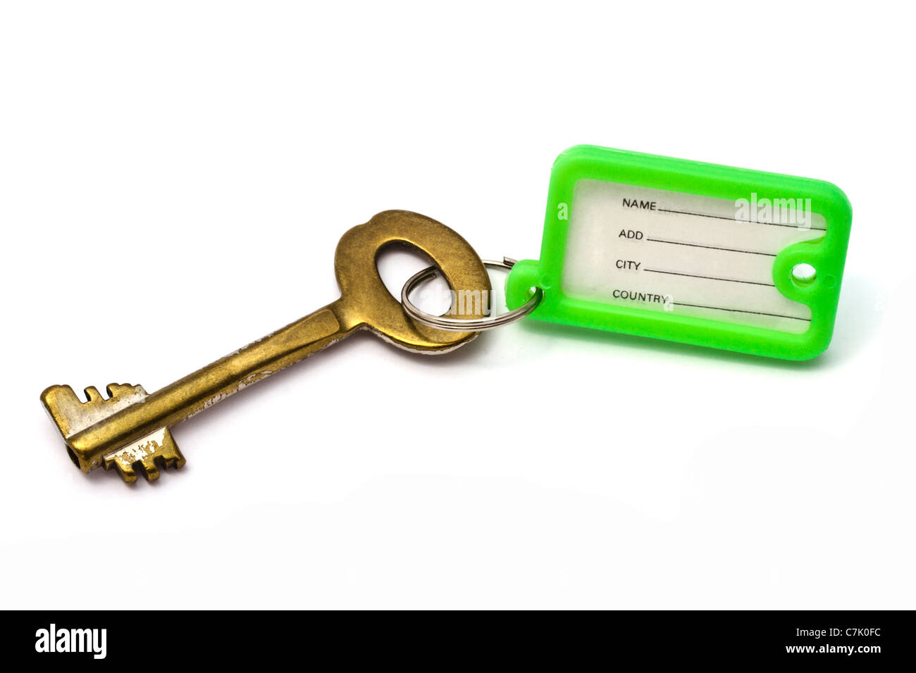 Old key with tag closeup on white background Stock Photo - Alamy