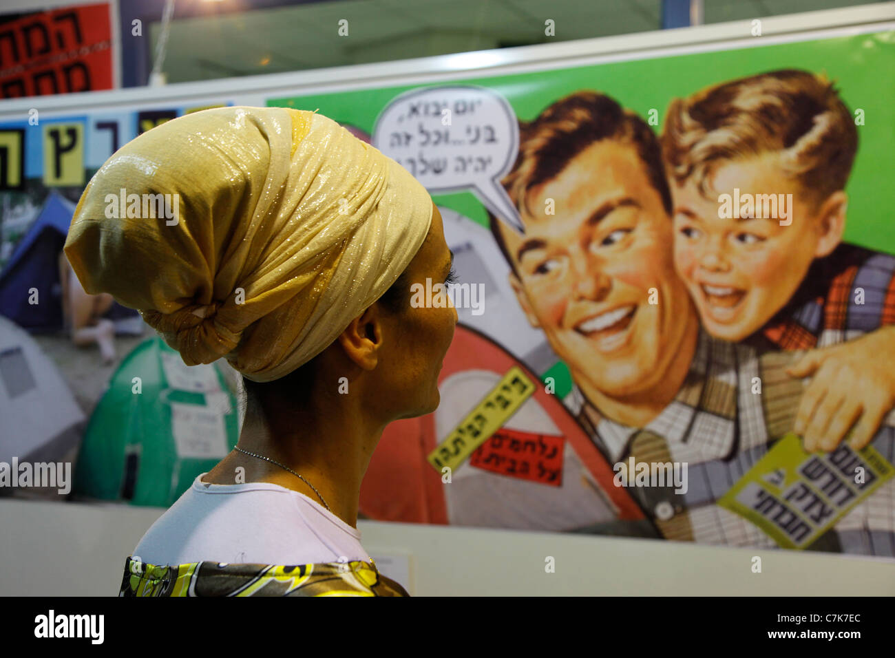 A visitor views artwork by Israeli caricaturist Zeev Engelmayer ...