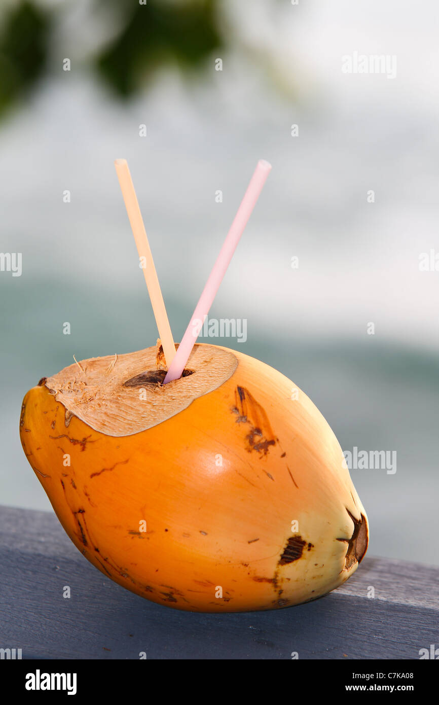 Coconut with straw Stock Photo - Alamy