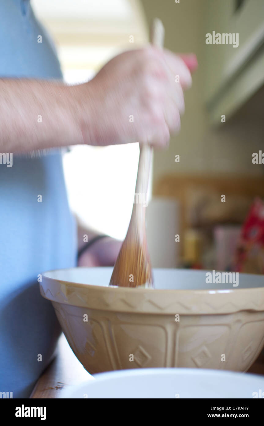 A man mixing red velvet cupcake mixture at home Stock Photo - Alamy