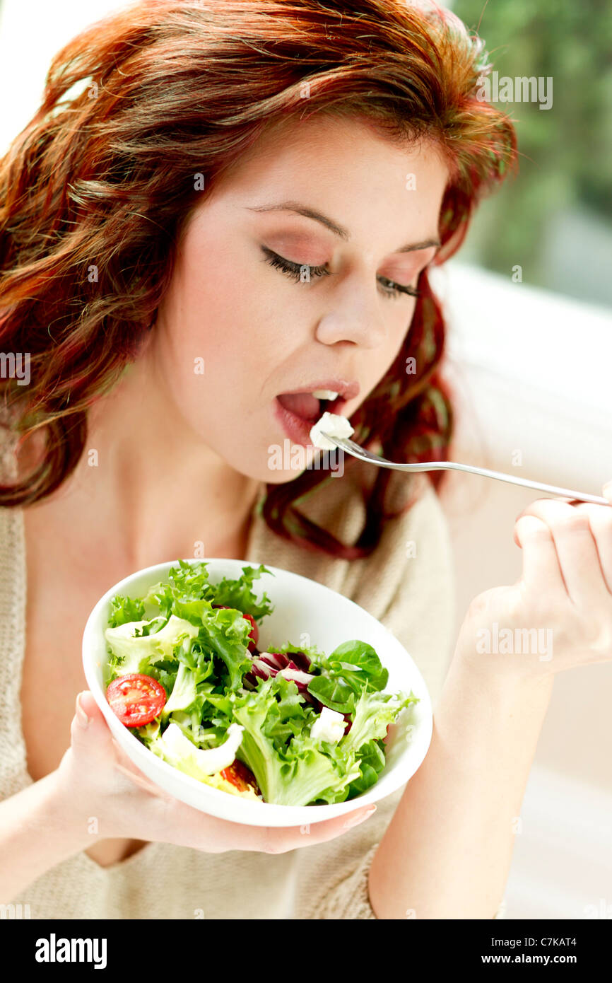 Girl eating salad Stock Photo - Alamy