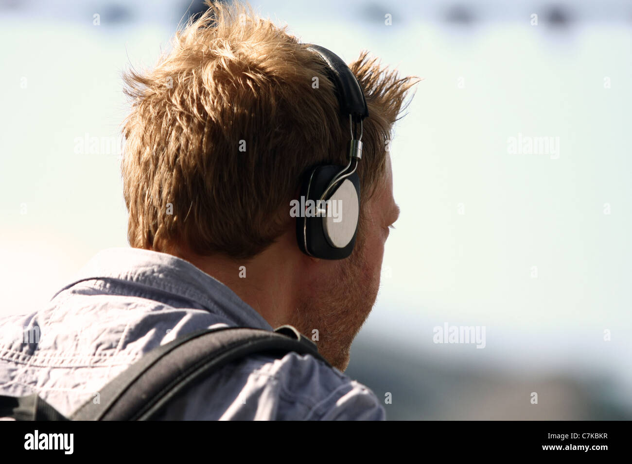 Rear view of a man wearing headphones in the street Stock Photo - Alamy