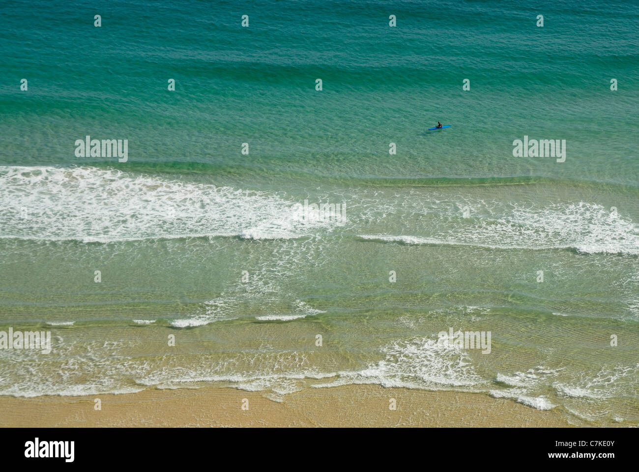 Empty beach scene with one kayaker paddling in beautiful sea Stock ...