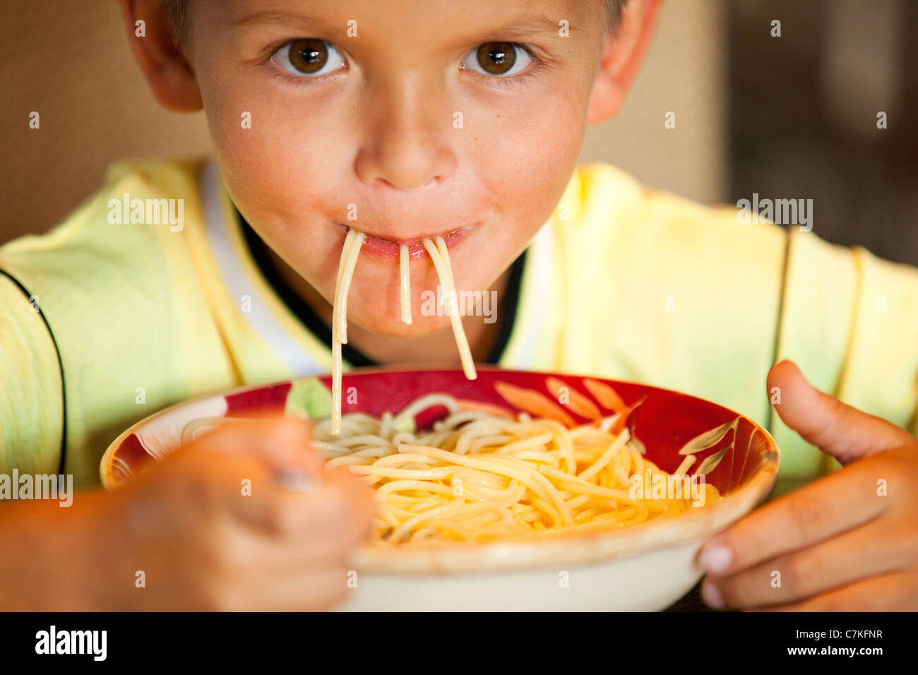 Boy eating spaghetti Stock Photo - Alamy