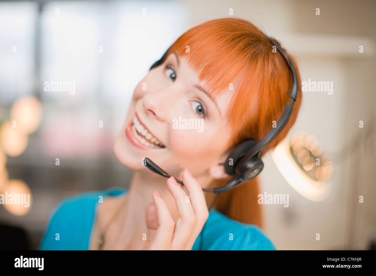 Smiling woman wearing headset Stock Photo - Alamy