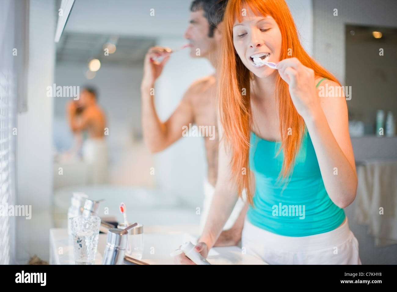 Couple brushing their teeth in bathroom Stock Photo - Alamy