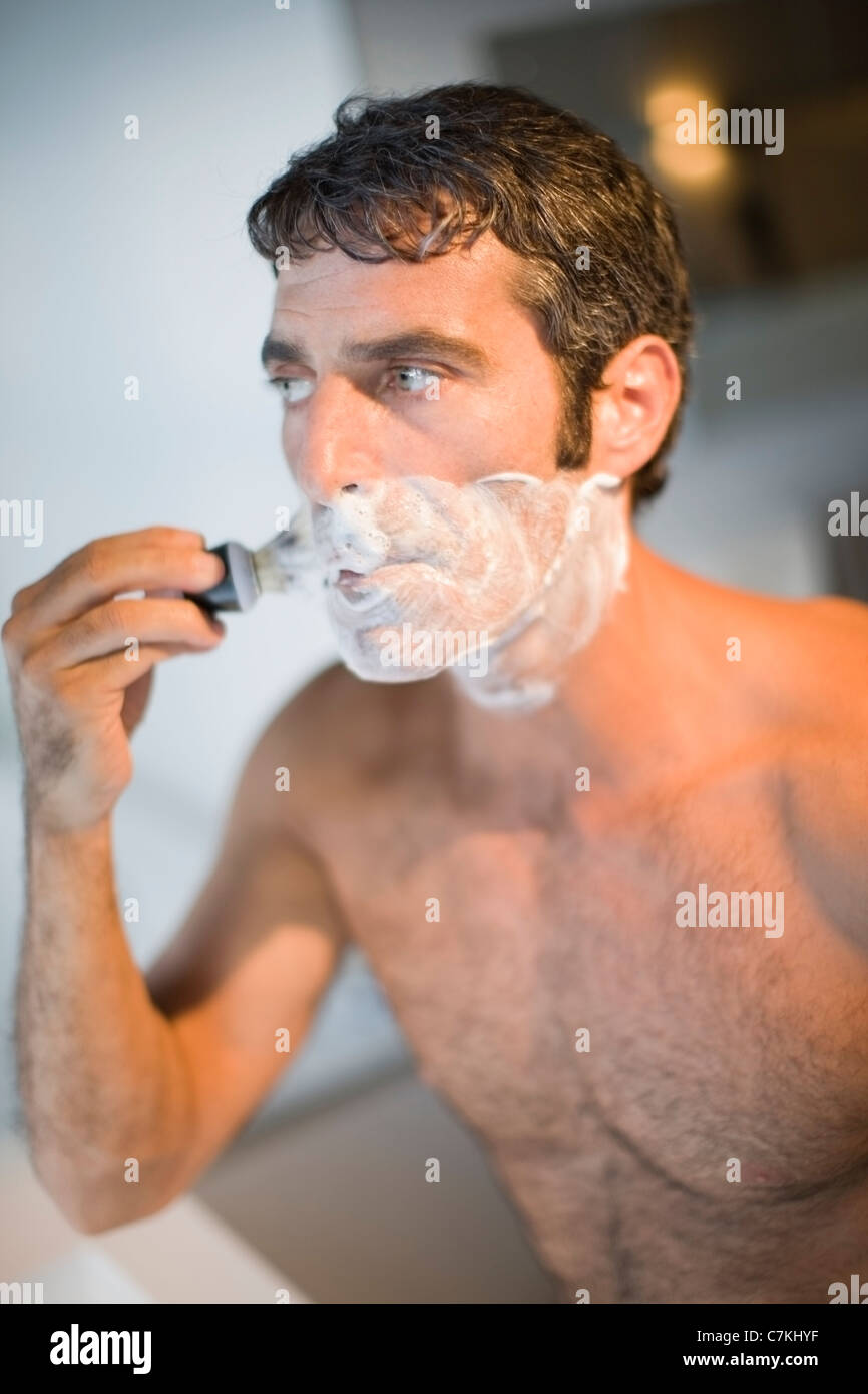Man lathering his face in bathroom Stock Photo - Alamy