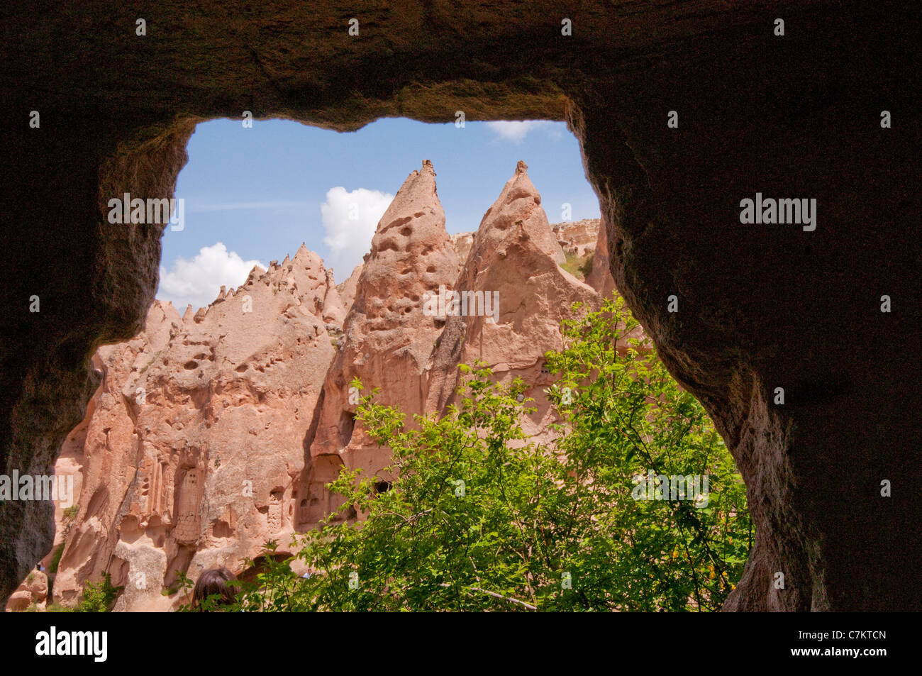 View of fairy chimneys and rock formations from inside one of the caves ...