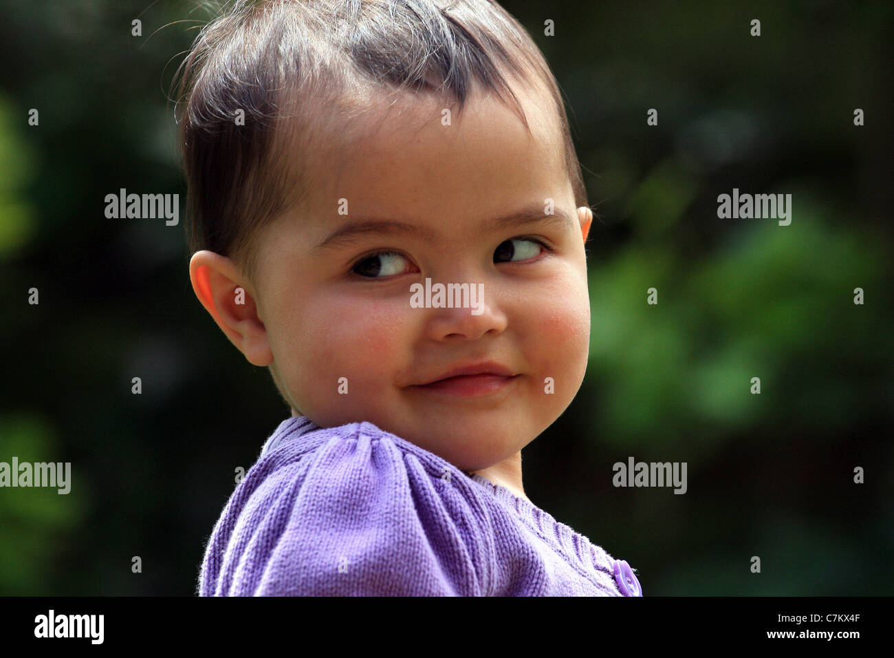 cute 2 year old girl looking over her shoulder Stock Photo - Alamy