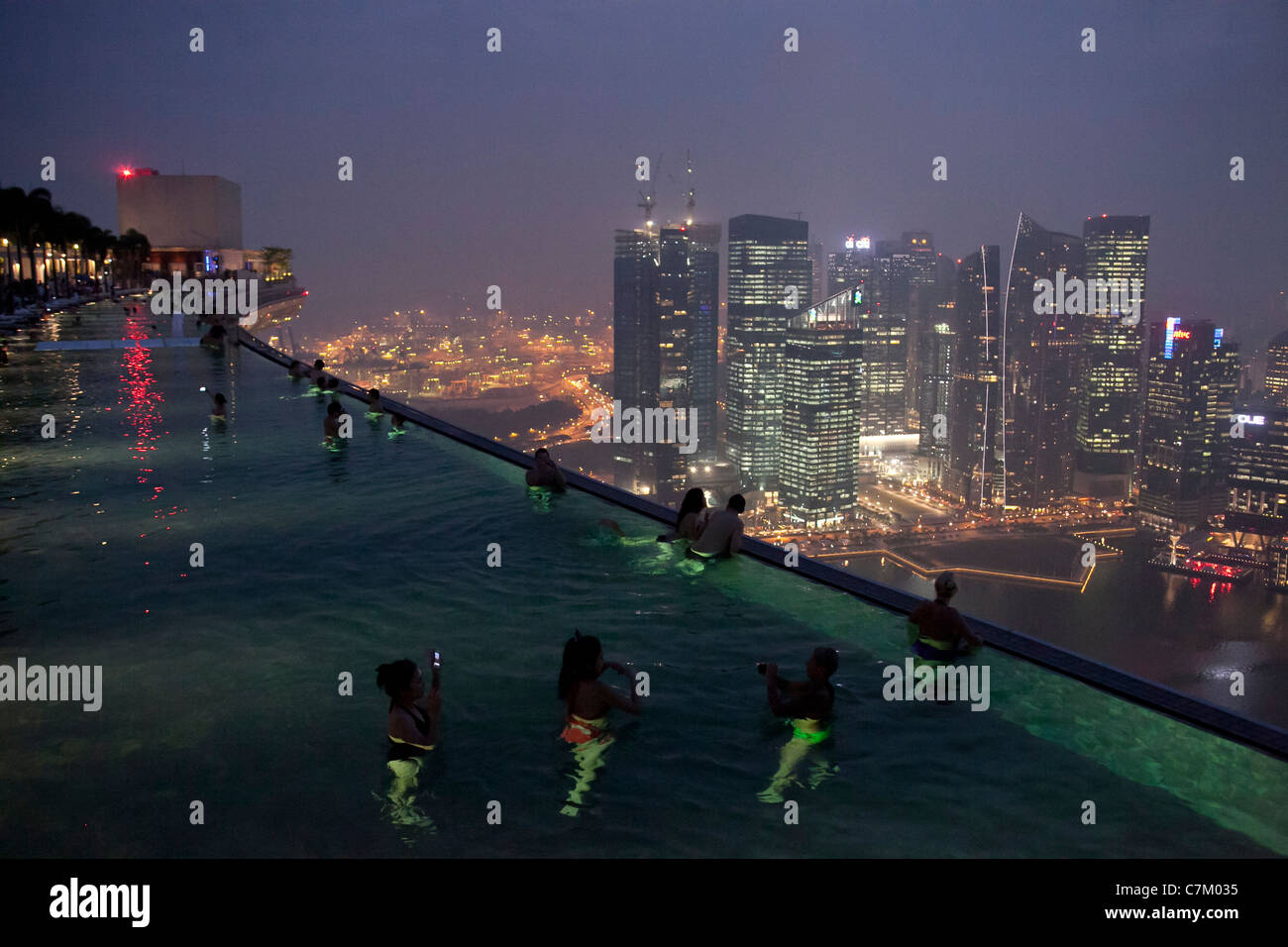 People swim in the infinity pool of the Skypark on top of the Marina ...