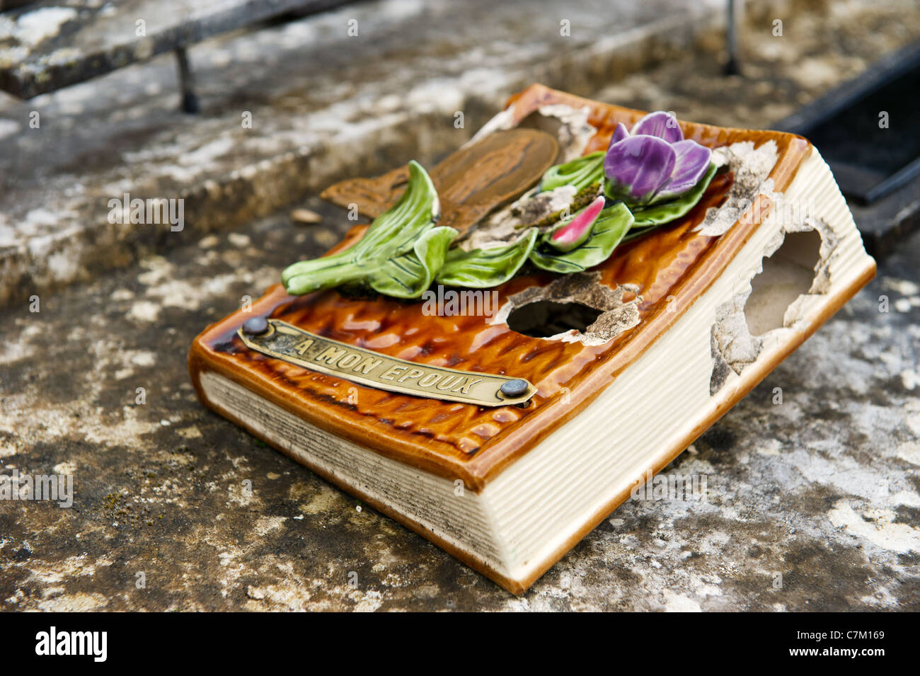 Old broken book voor memoriam at French grave Stock Photo - Alamy