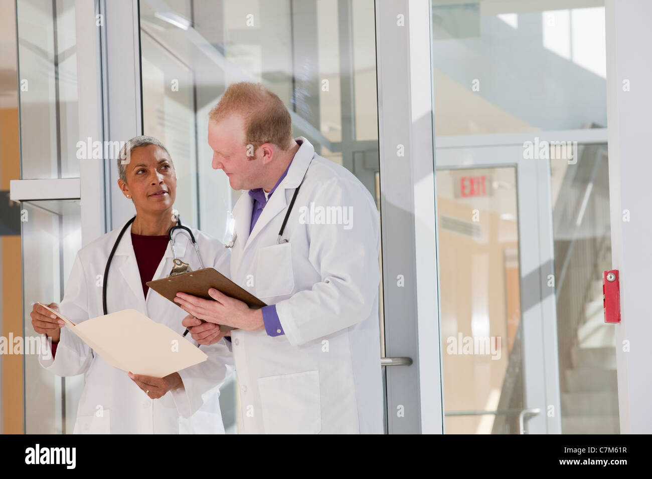 Two doctors discussing a medical report in hospital Stock Photo - Alamy