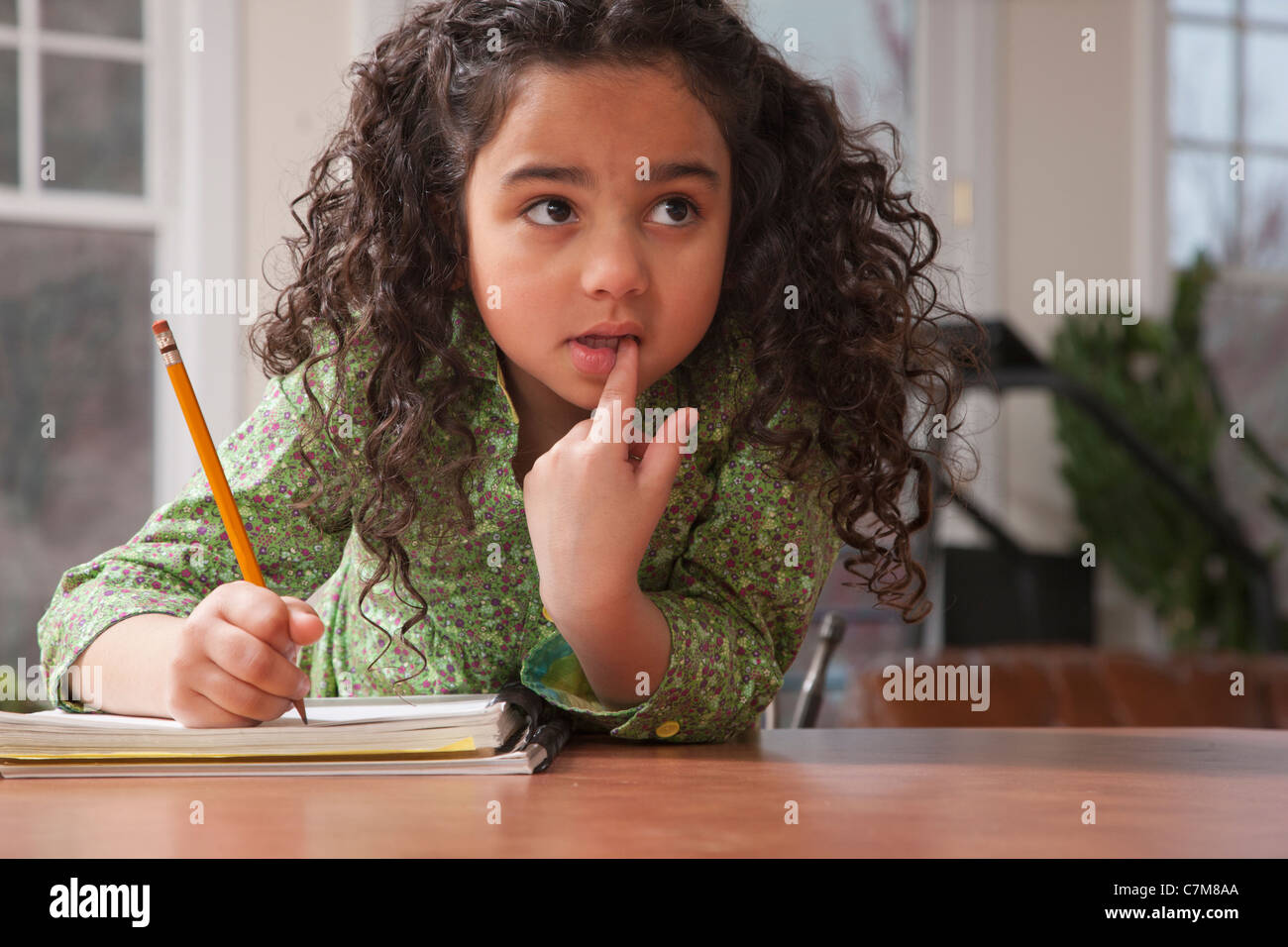 Hispanic girl doing her school work Stock Photo - Alamy