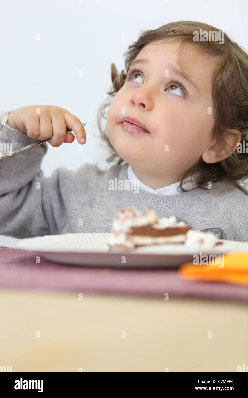 Child eating cream cake Stock Photo - Alamy