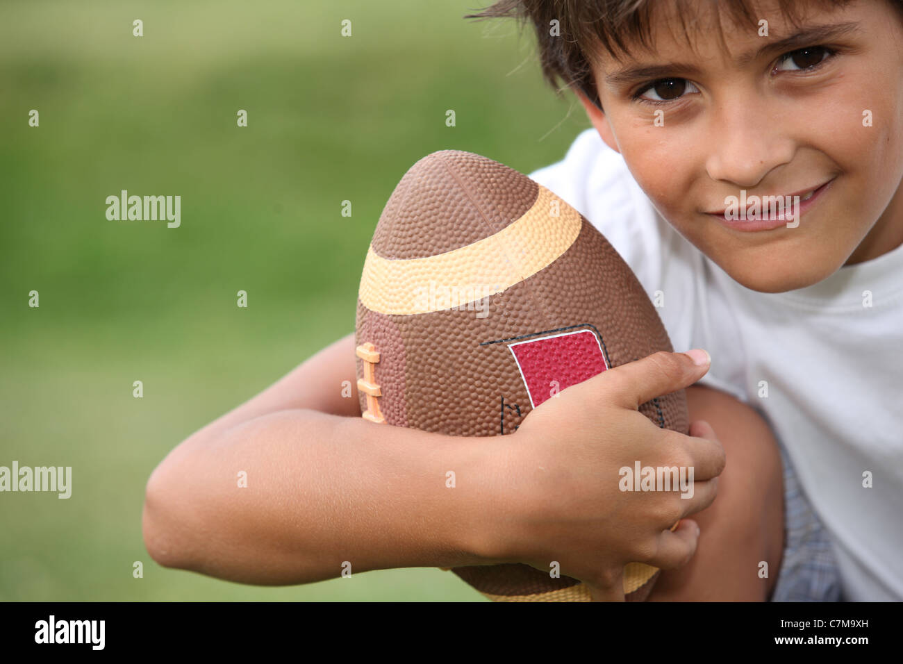 Young boy playing rugby Stock Photo - Alamy