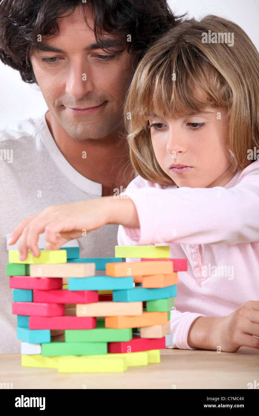 Father and daughter building a tower of blocks Stock Photo - Alamy