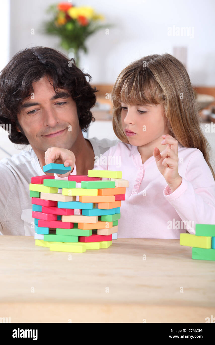 Father and child playing a game together Stock Photo - Alamy