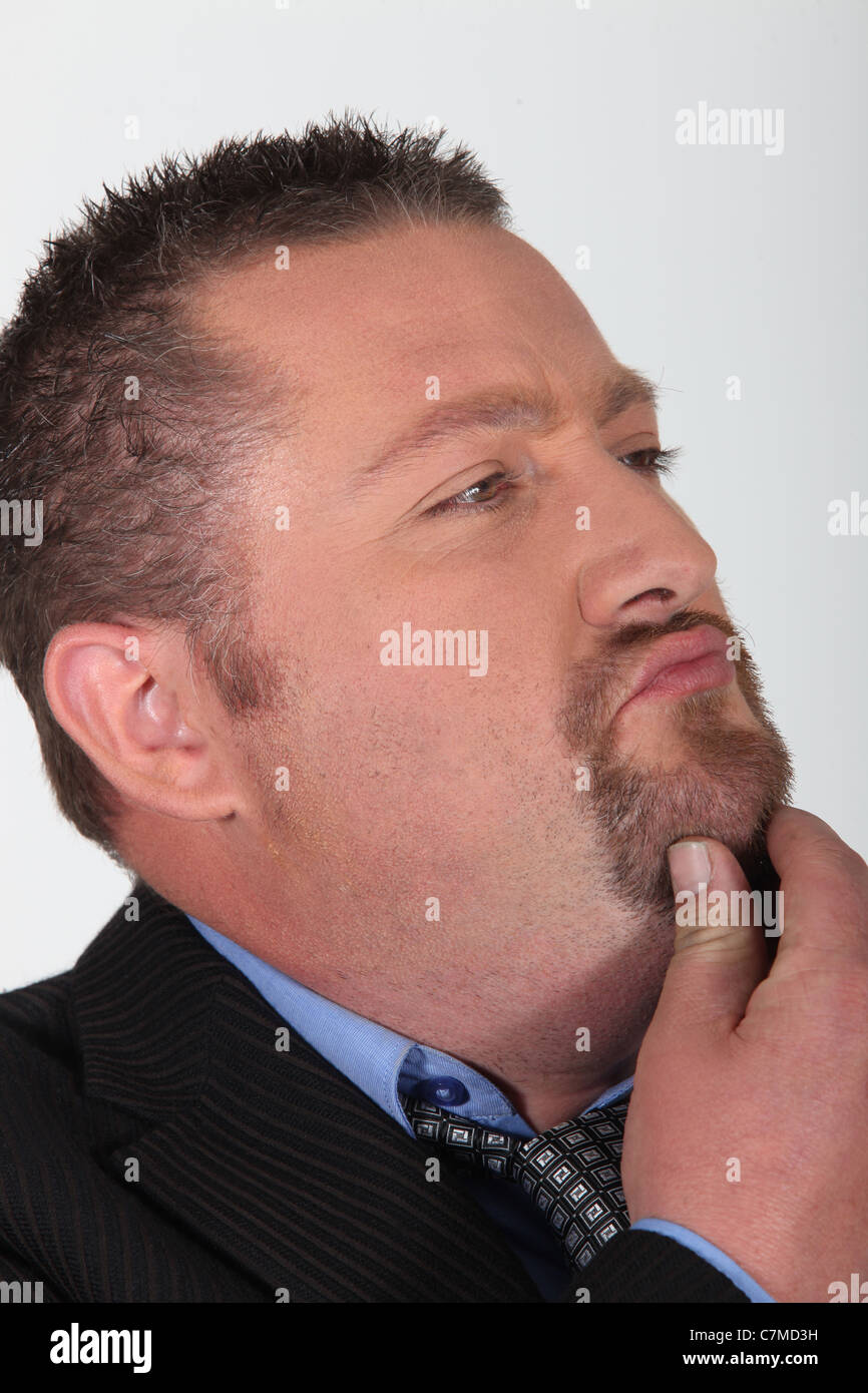 Man scratching his chin Stock Photo - Alamy