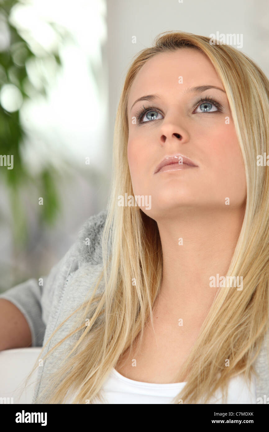 Young woman at home looking at the ceiling Stock Photo - Alamy