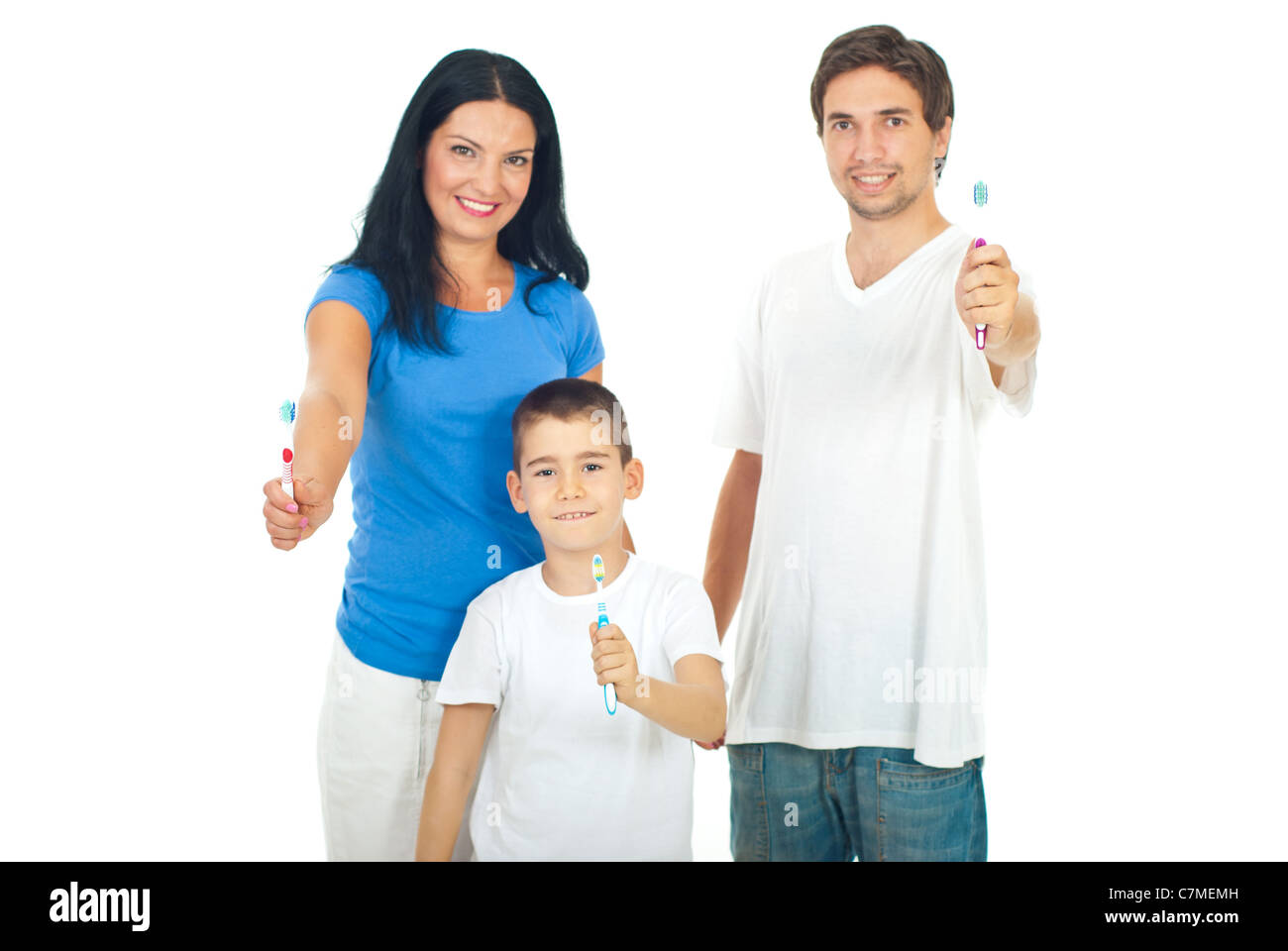 Happy family giving or showing their toothbrushes isolated on white ...