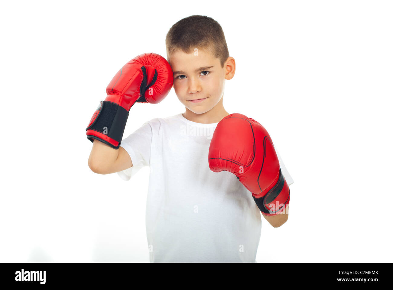 Child boy with soft smile with red boxing gloves isolated on white ...