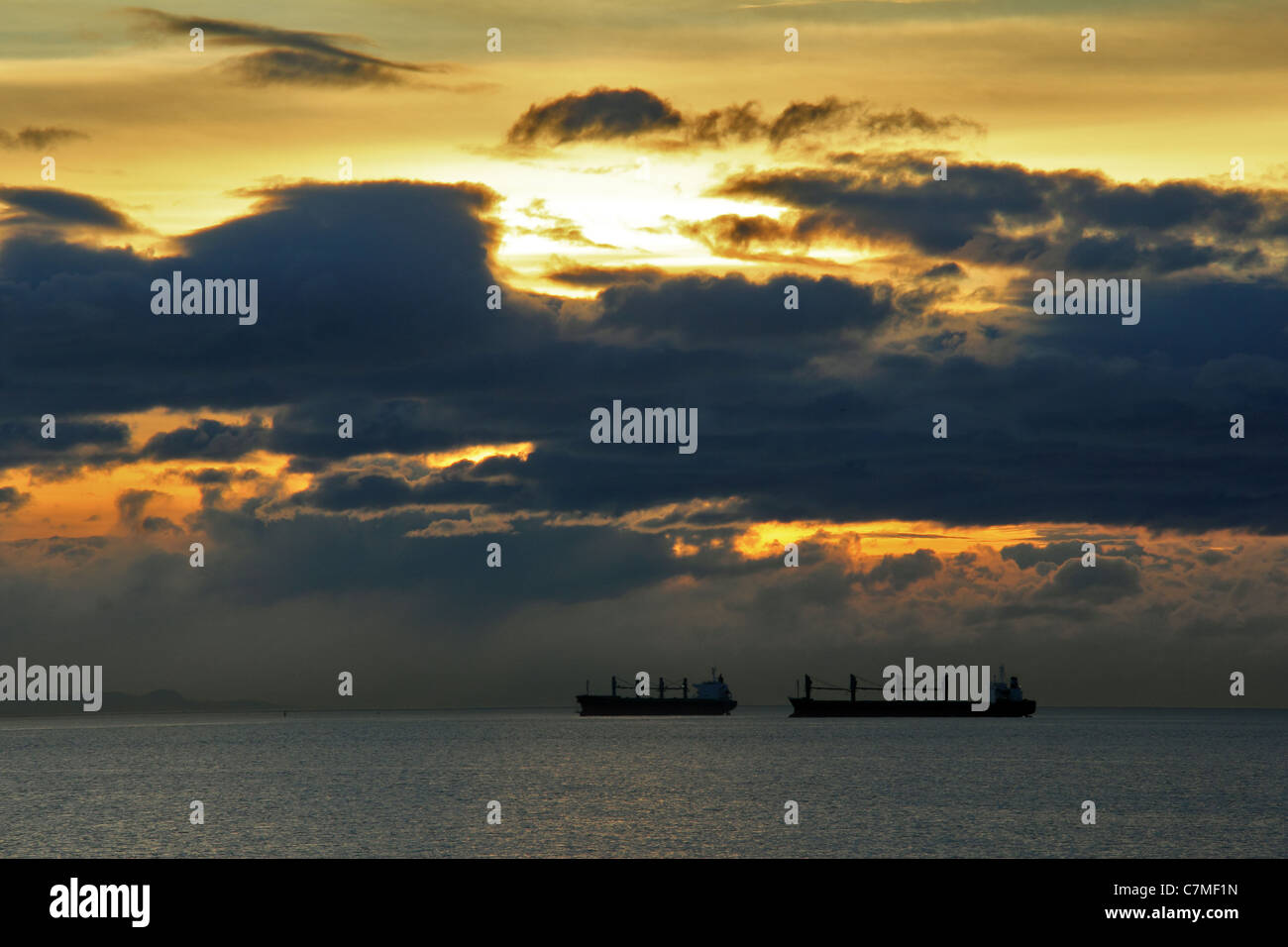 Commercial Ships at sunset Stock Photo - Alamy