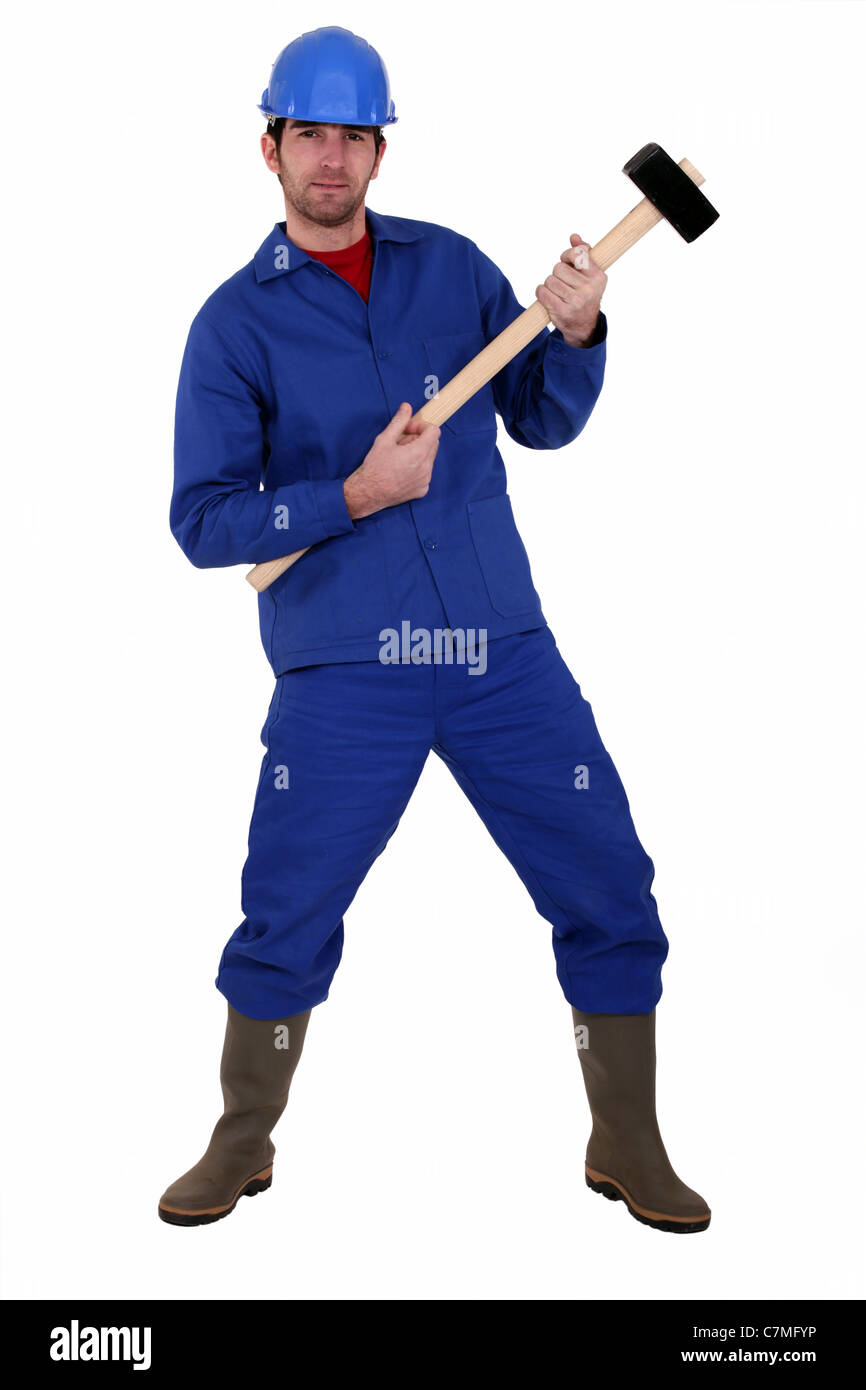 Man playing a sledgehammer like a guitar Stock Photo - Alamy