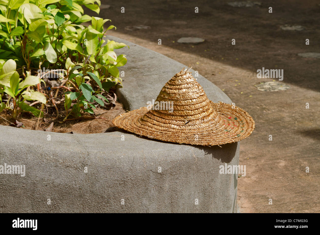 Gardeners straw hat abandoned on a concrete wall Stock Photo - Alamy