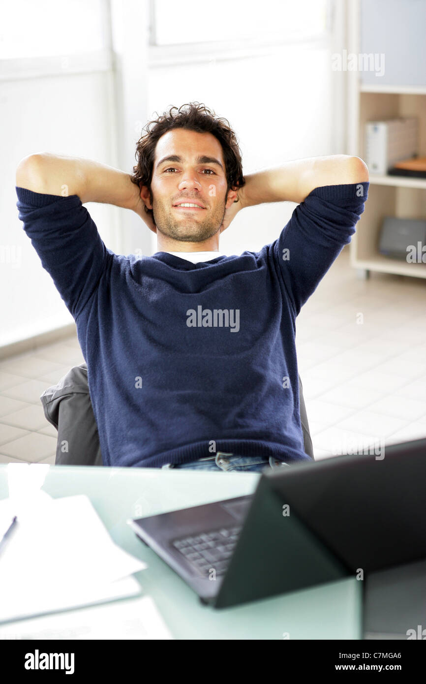 businessman stretching on his desk Stock Photo - Alamy
