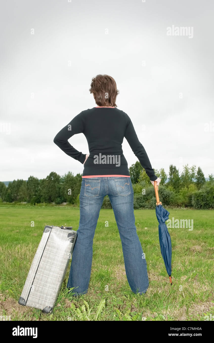 Rear view of a young woman standing on a meadow Stock Photo - Alamy