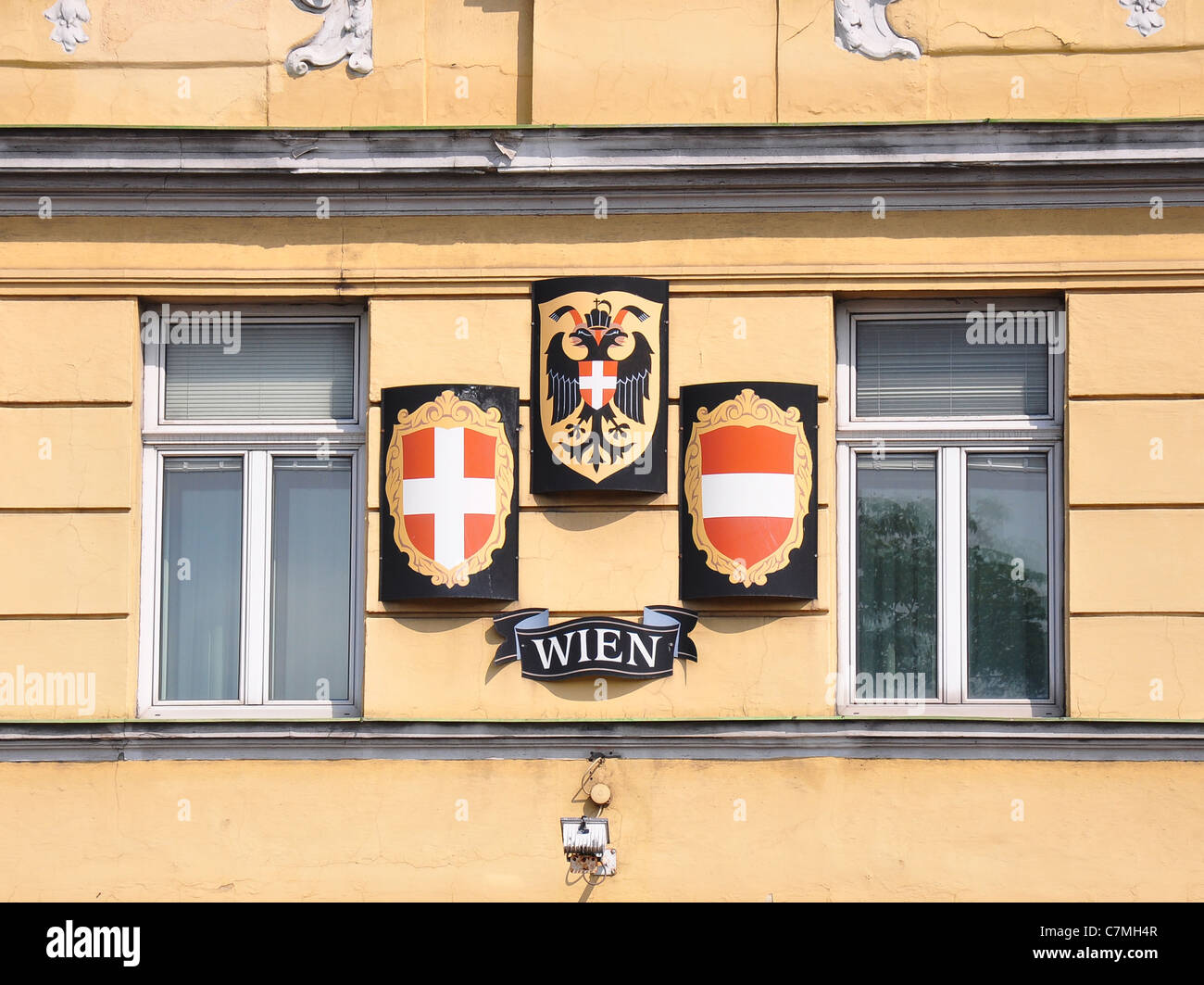 Coat of arms and flag of Vienna and Austria at facade in Vienna Stock ...