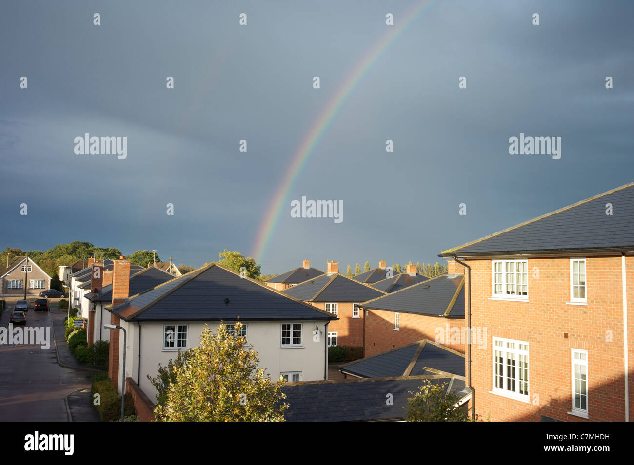 Evening rainbow over houses Stock Photo - Alamy