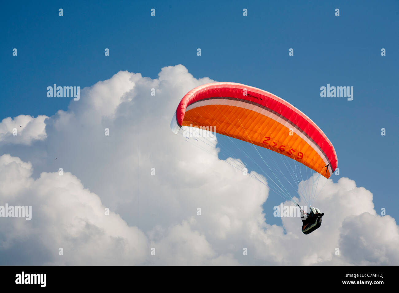 A Paraglider flying in the Clouds Stock Photo - Alamy