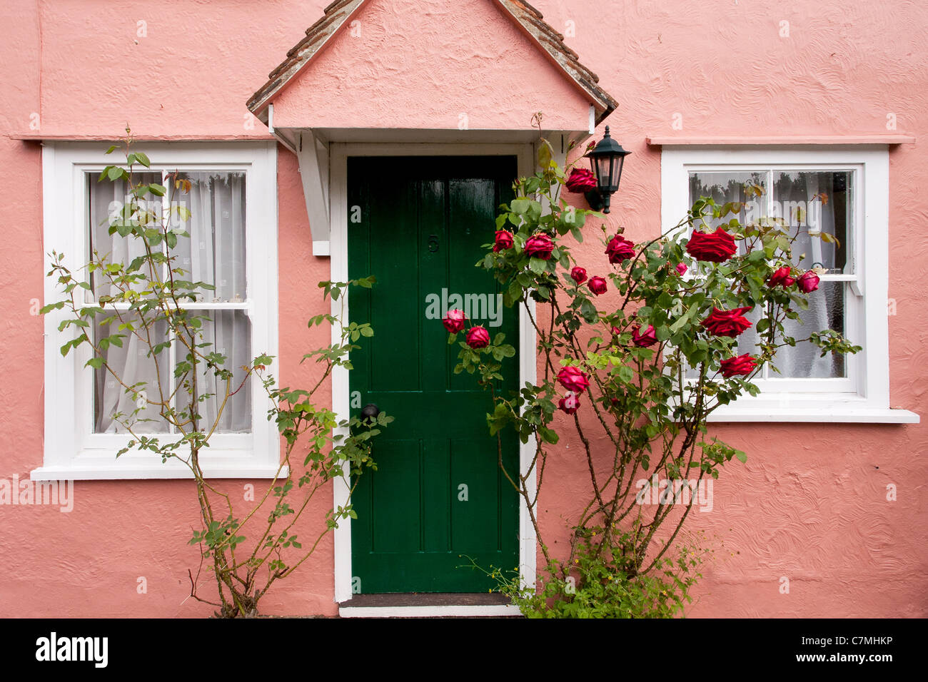 Pink Cottage with roses Stock Photo - Alamy