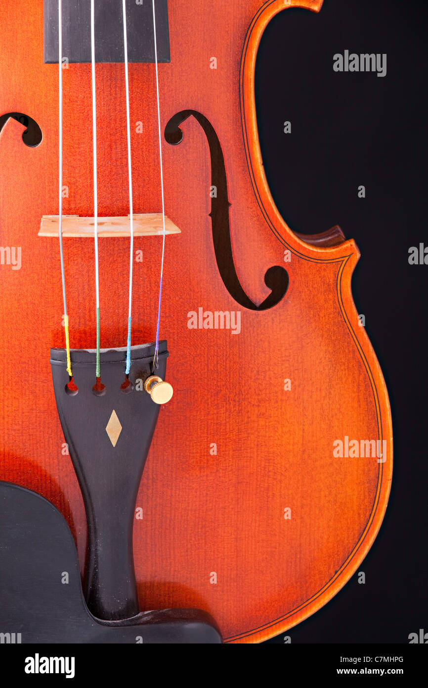 A violin viola body up close isolated against a black background Stock ...